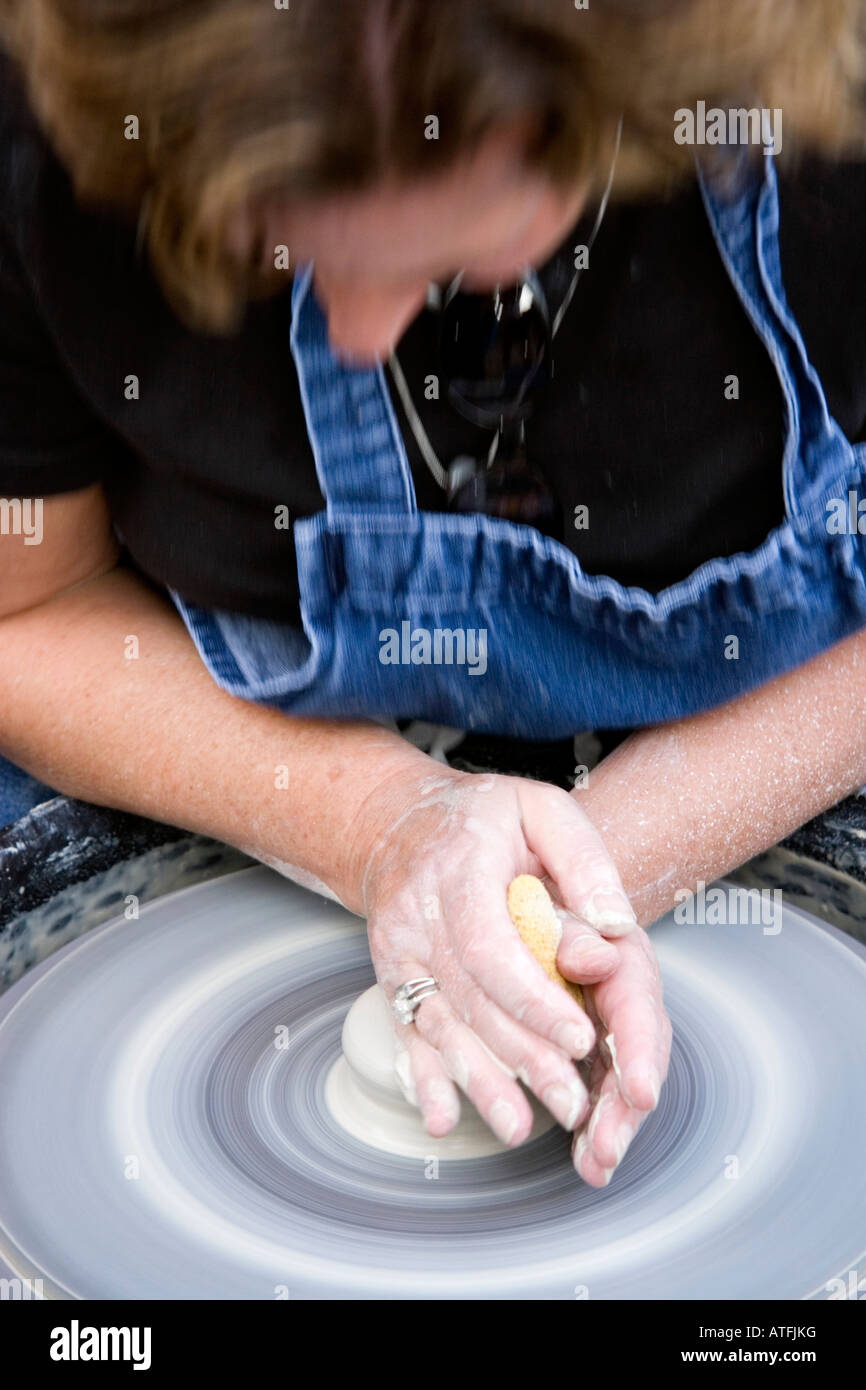 Woman working on pottery wheel Stock Photo - Alamy