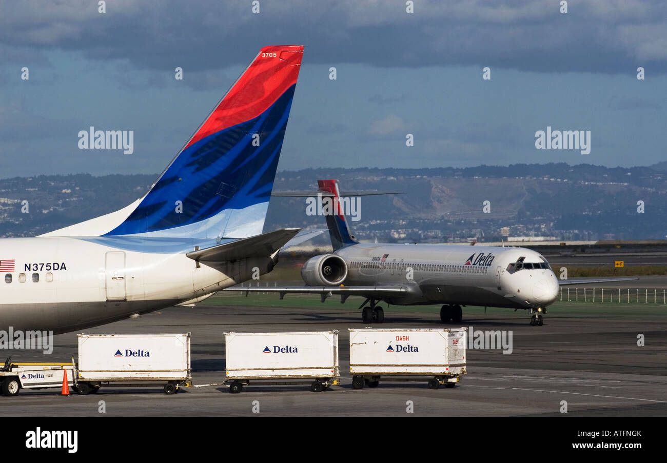 A Delta Airlines airplane taxis past another Delta aircraft at San ...