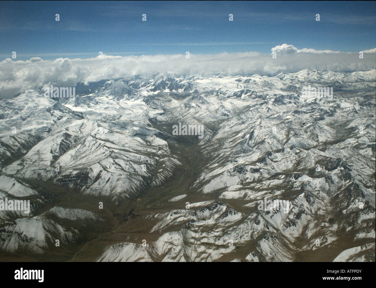 An aerial view of the Andes encompassed in snow with the atmospheric ...