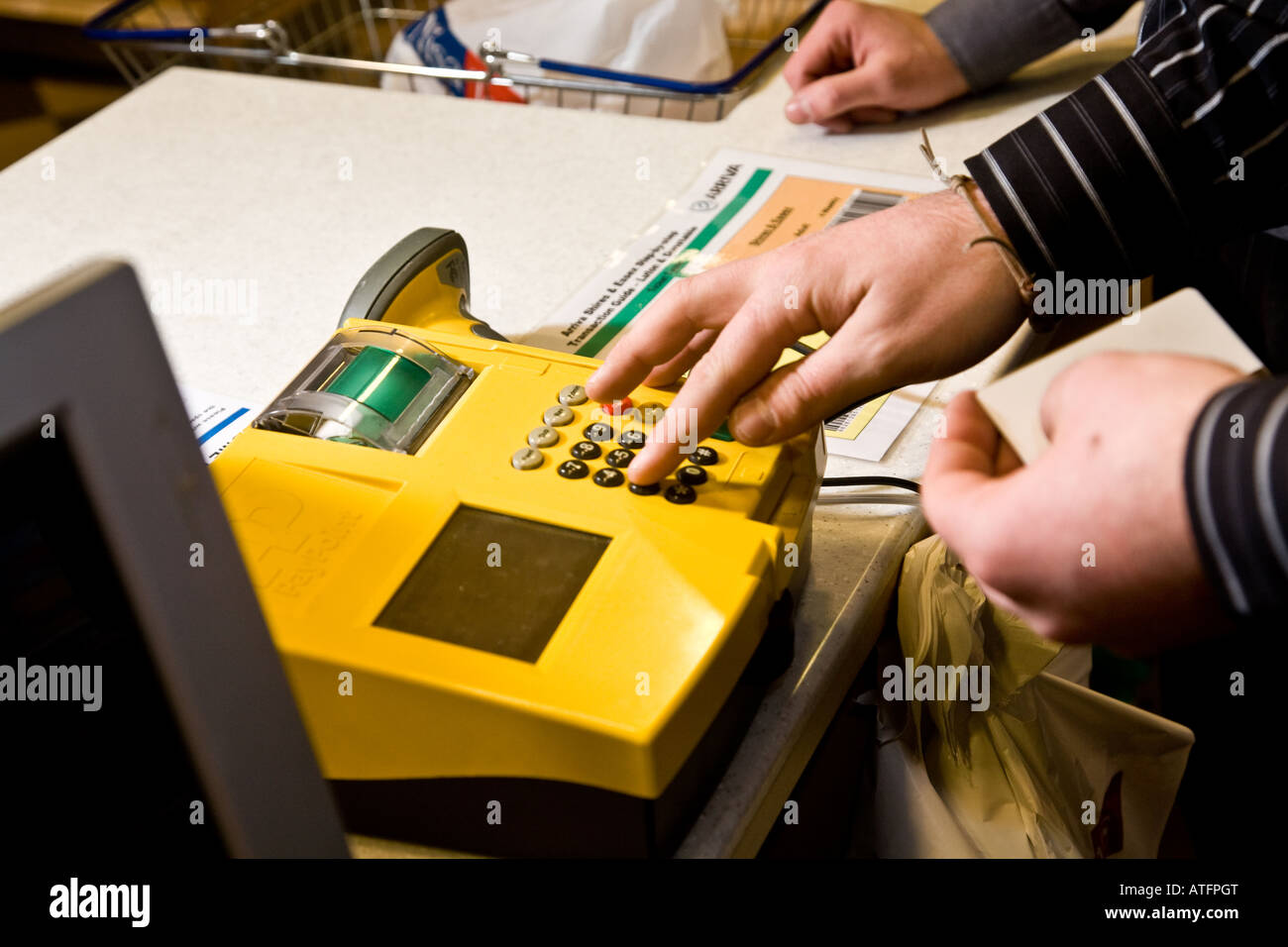 Store staff processing a Paypoint payment at a Convienence store Stock ...