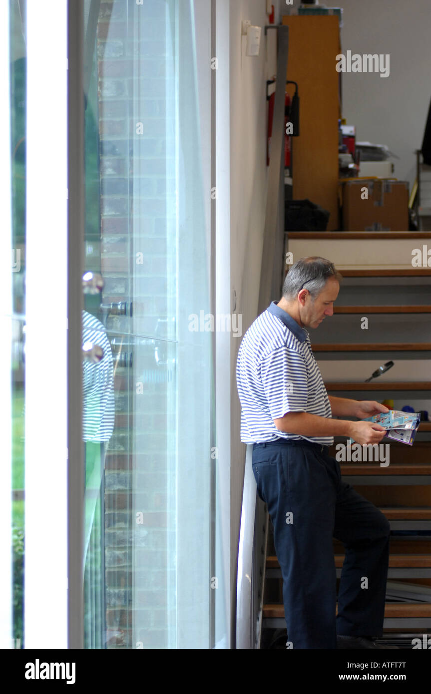 British business man in casual clothes reading in modern corporate ...
