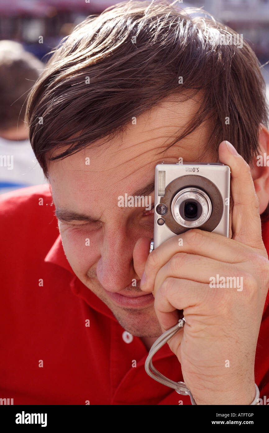 Man taking a picture with his digital camera Stock Photo - Alamy