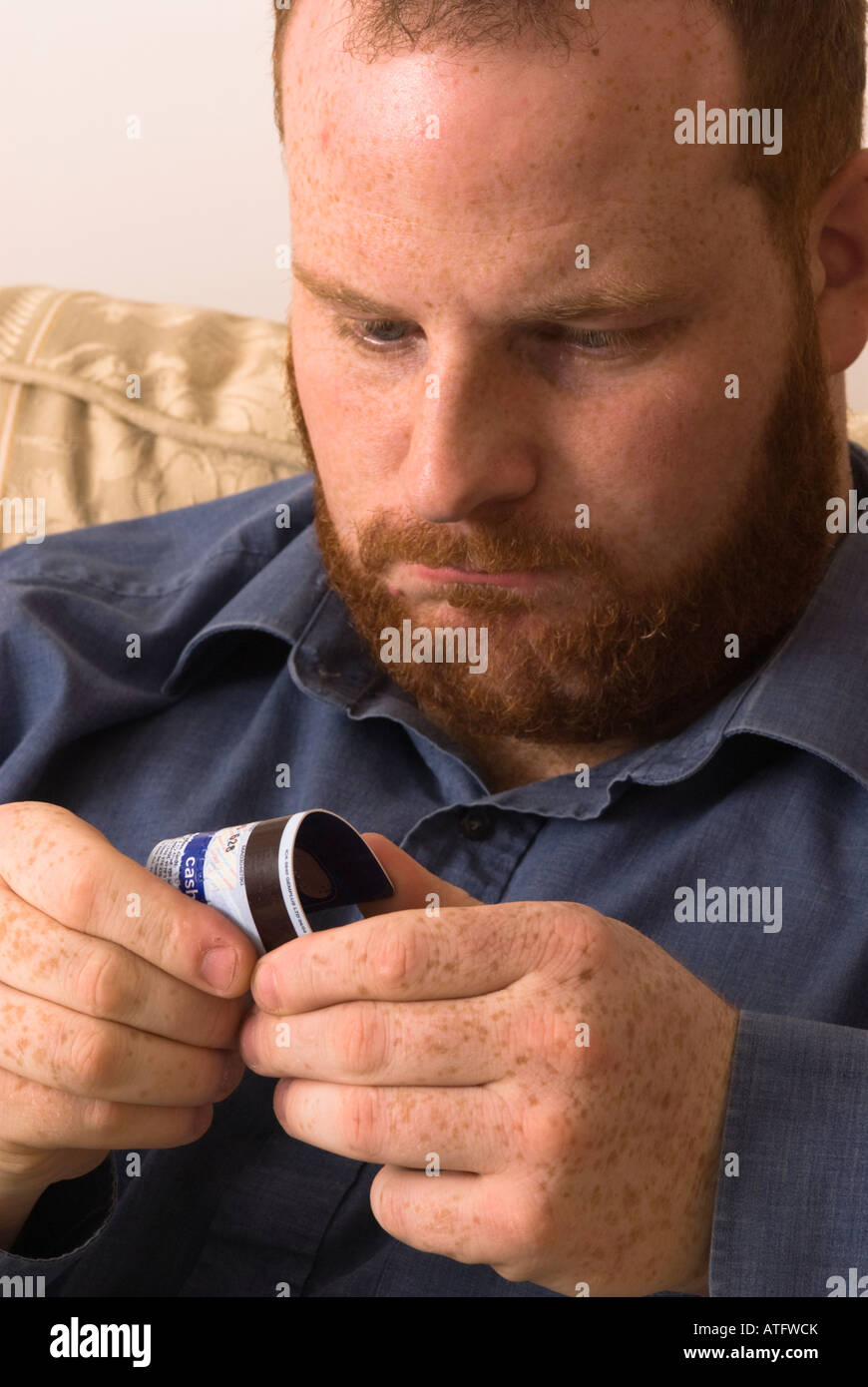 angry young man destroying credit debit bank card to avoid debt and ...
