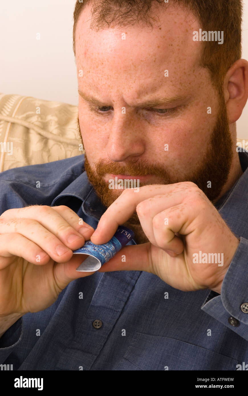 angry young man destroying credit debit bank card to avoid debt and ...