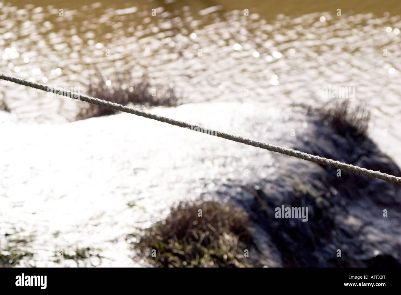 rope stretched across mudbank Stock Photo - Alamy