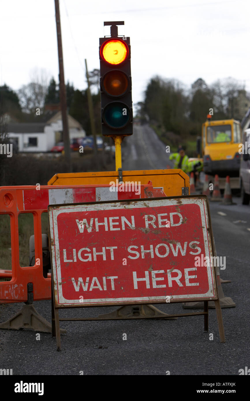 temporary traffic sign red light shows wait here message roadworks ...