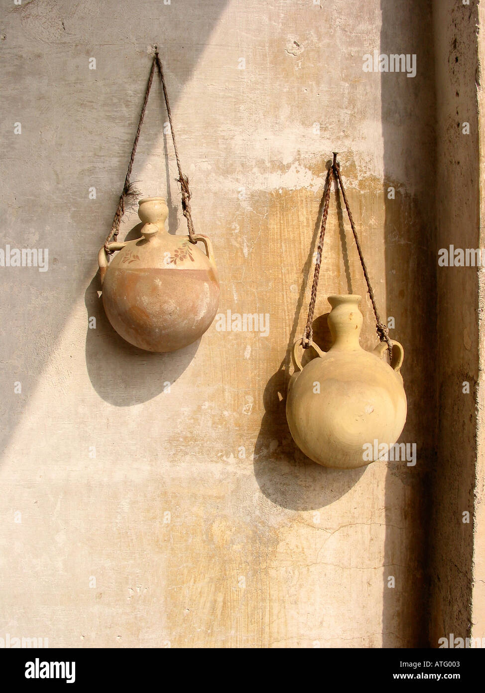 Pitchers hung up in a wall Stock Photo - Alamy