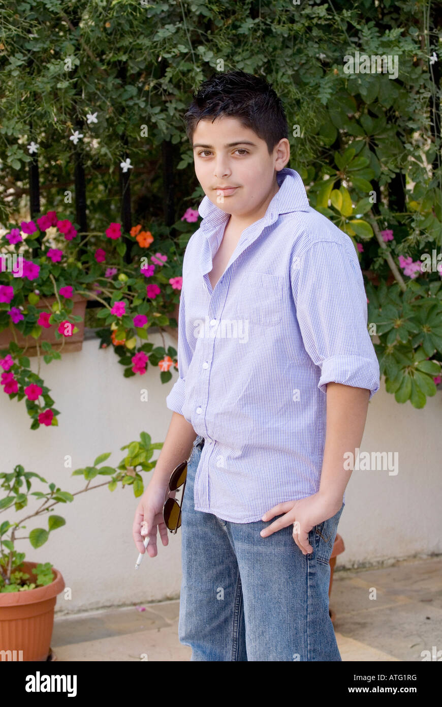 Young boy standing outdoors Stock Photo - Alamy