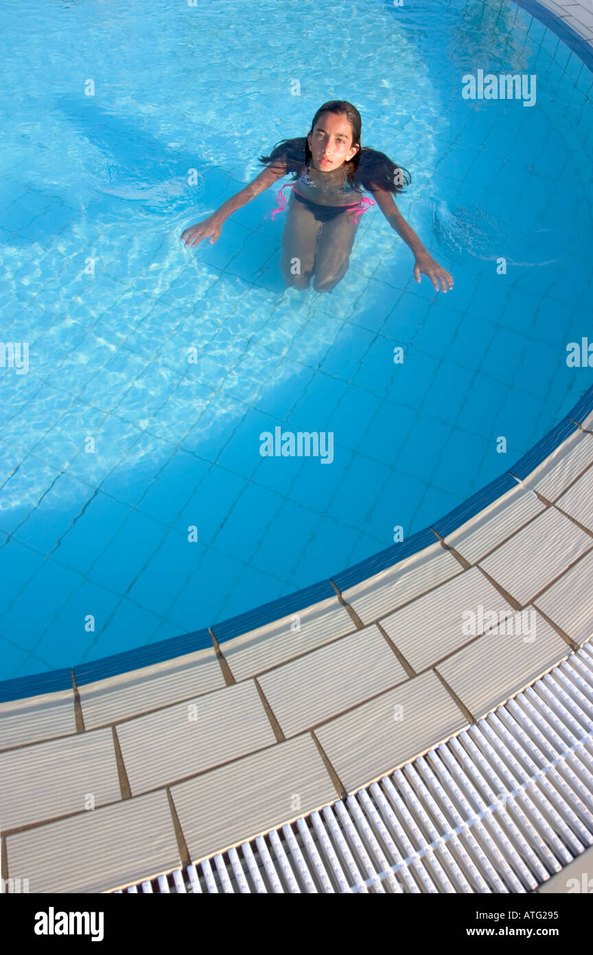 Teenage Girl Relaxing in Swimming Pool Stock Photo - Alamy