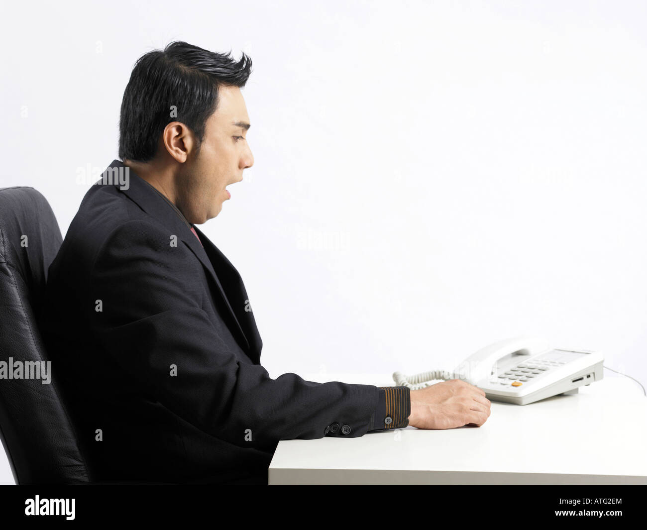 a tired businessman waiting for phone call Stock Photo - Alamy