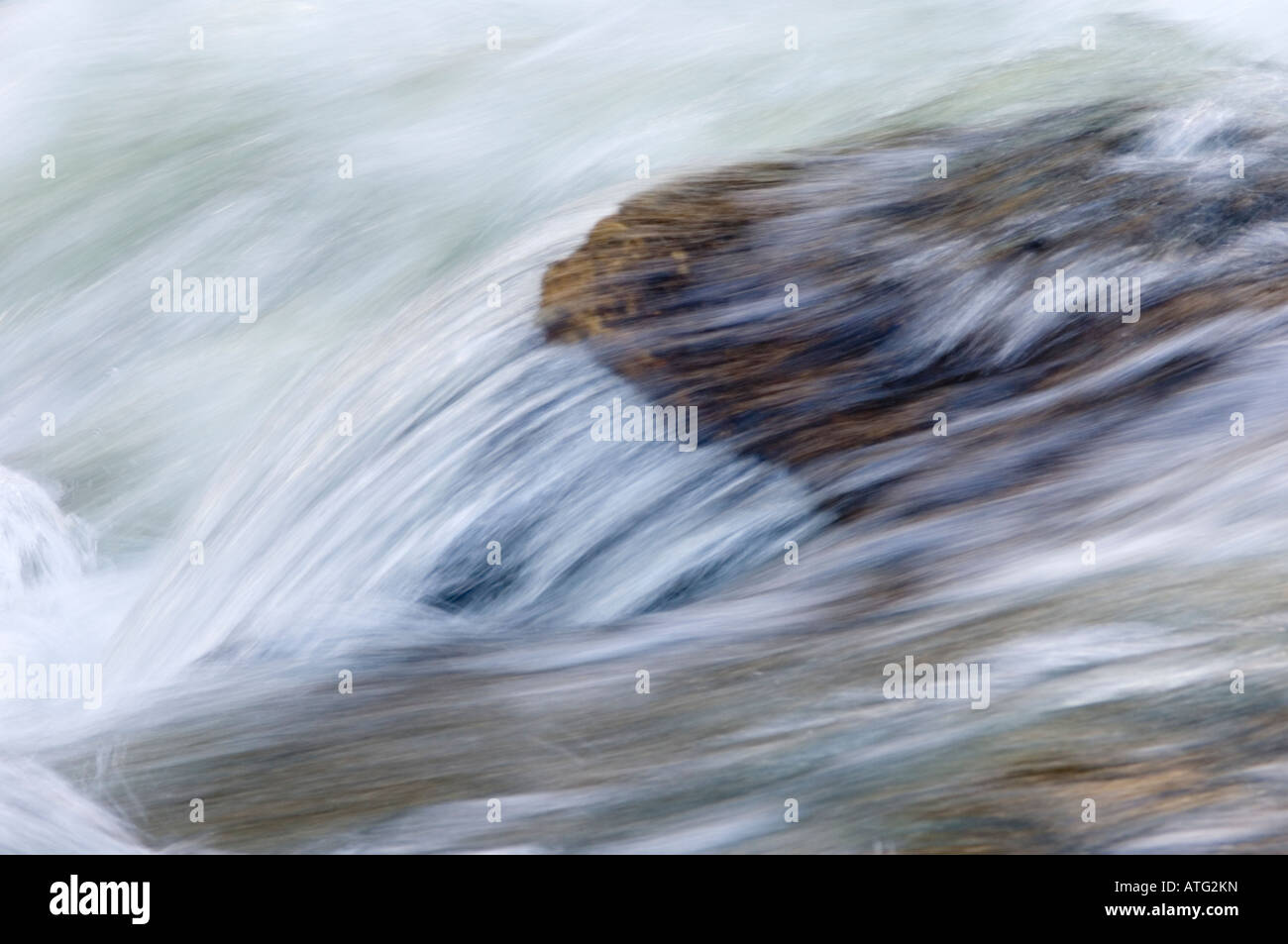Water flowing over granite rock in a river, the River Quoich in the ...