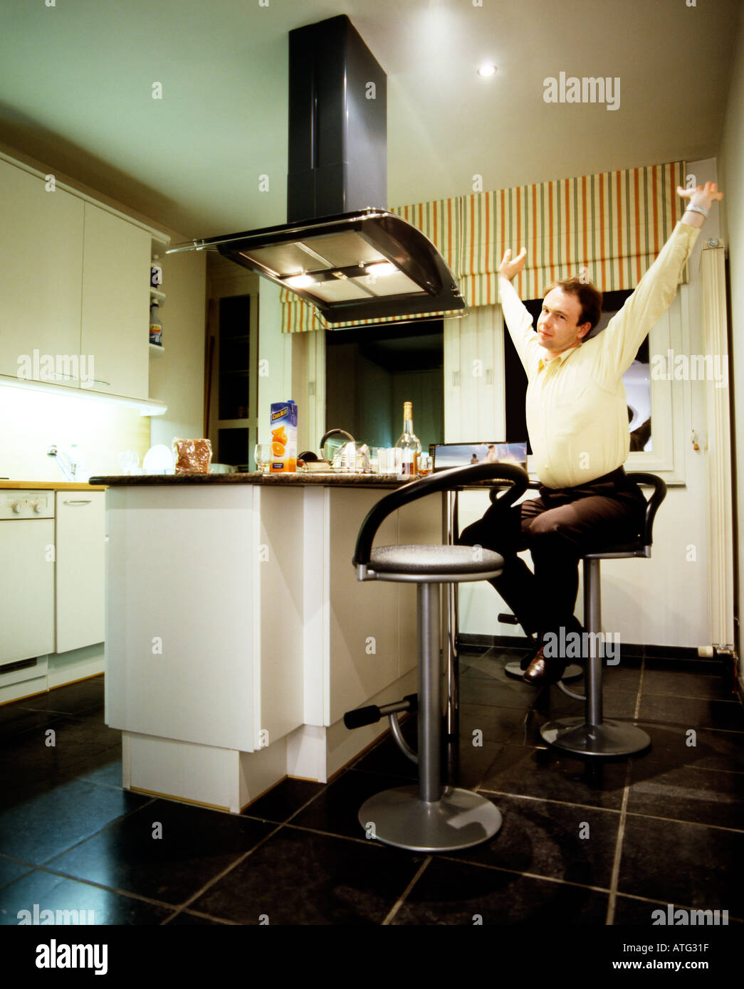 Man stretching at a kitchen Stock Photo - Alamy