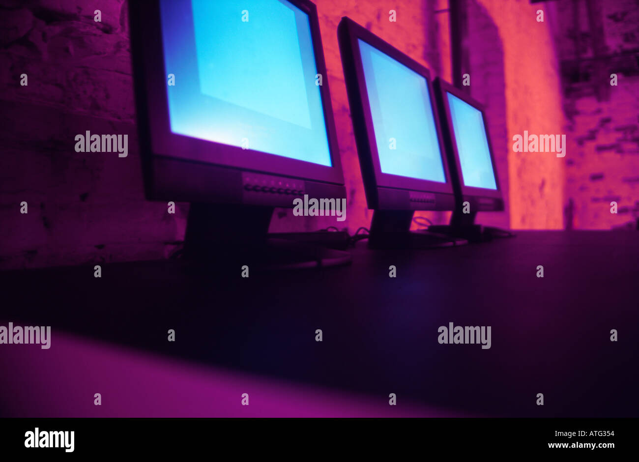 Row of LCD monitors in a dimly lit room Stock Photo - Alamy