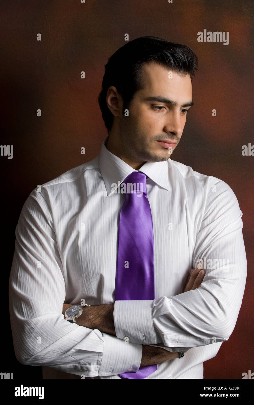Serious confident business man arms folded looking down Stock Photo - Alamy Serious confident business man arms folded looking down Stock Photo - Alamy