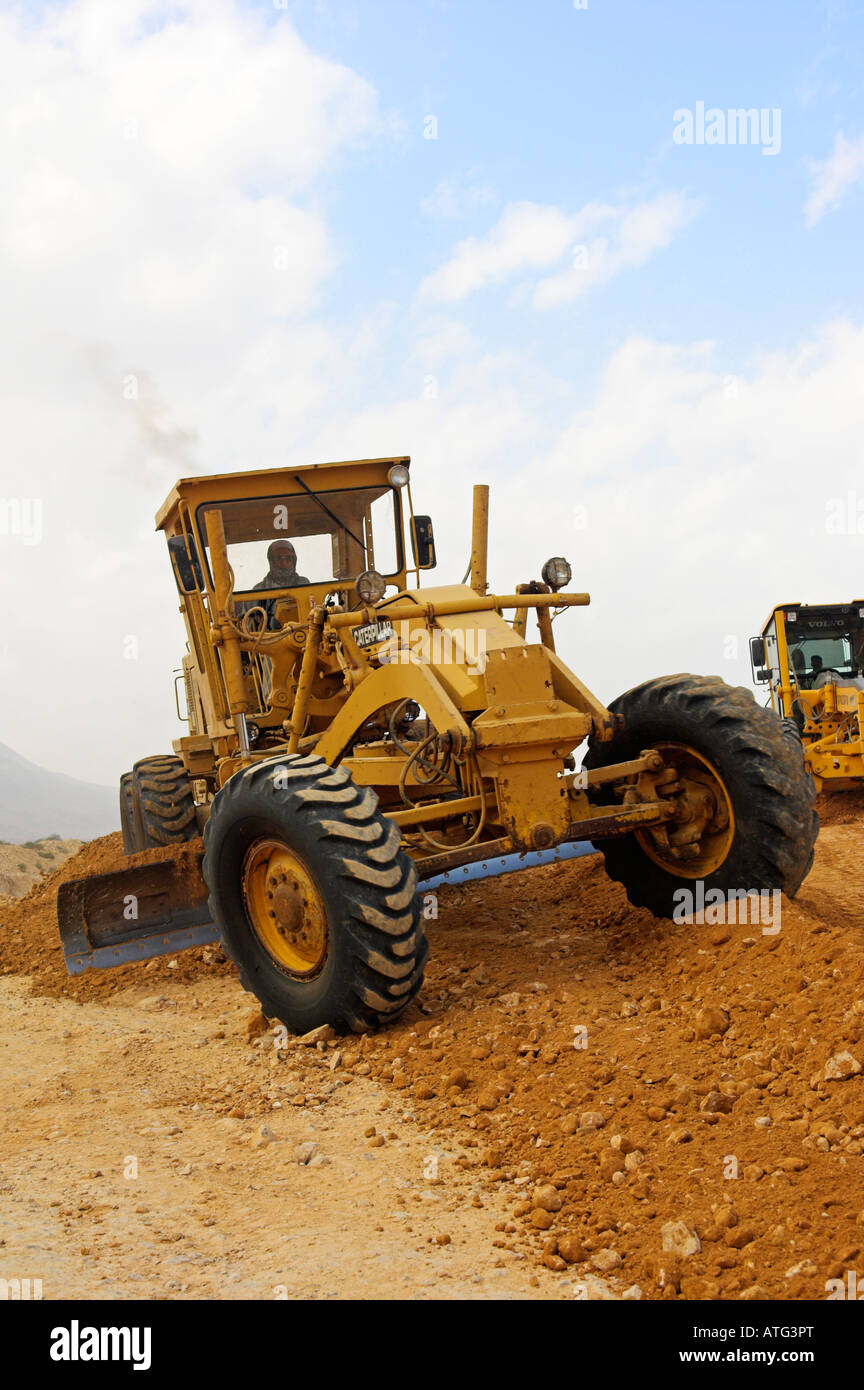 Road scraper building new highway Oman Stock Photo - Alamy