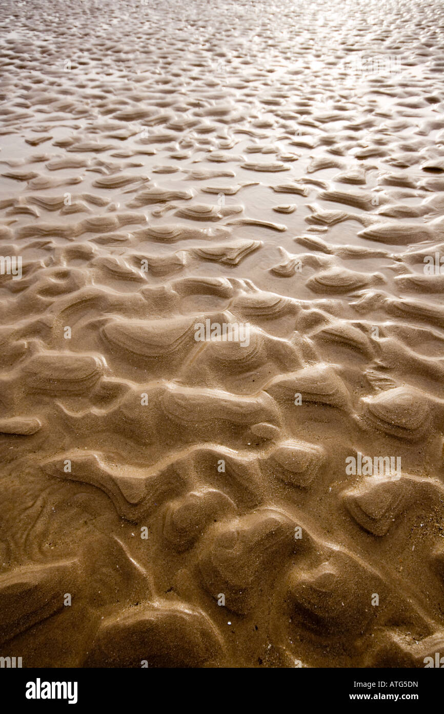 Ripples in the sand of a beach left by the receeding tide Stock Photo ...