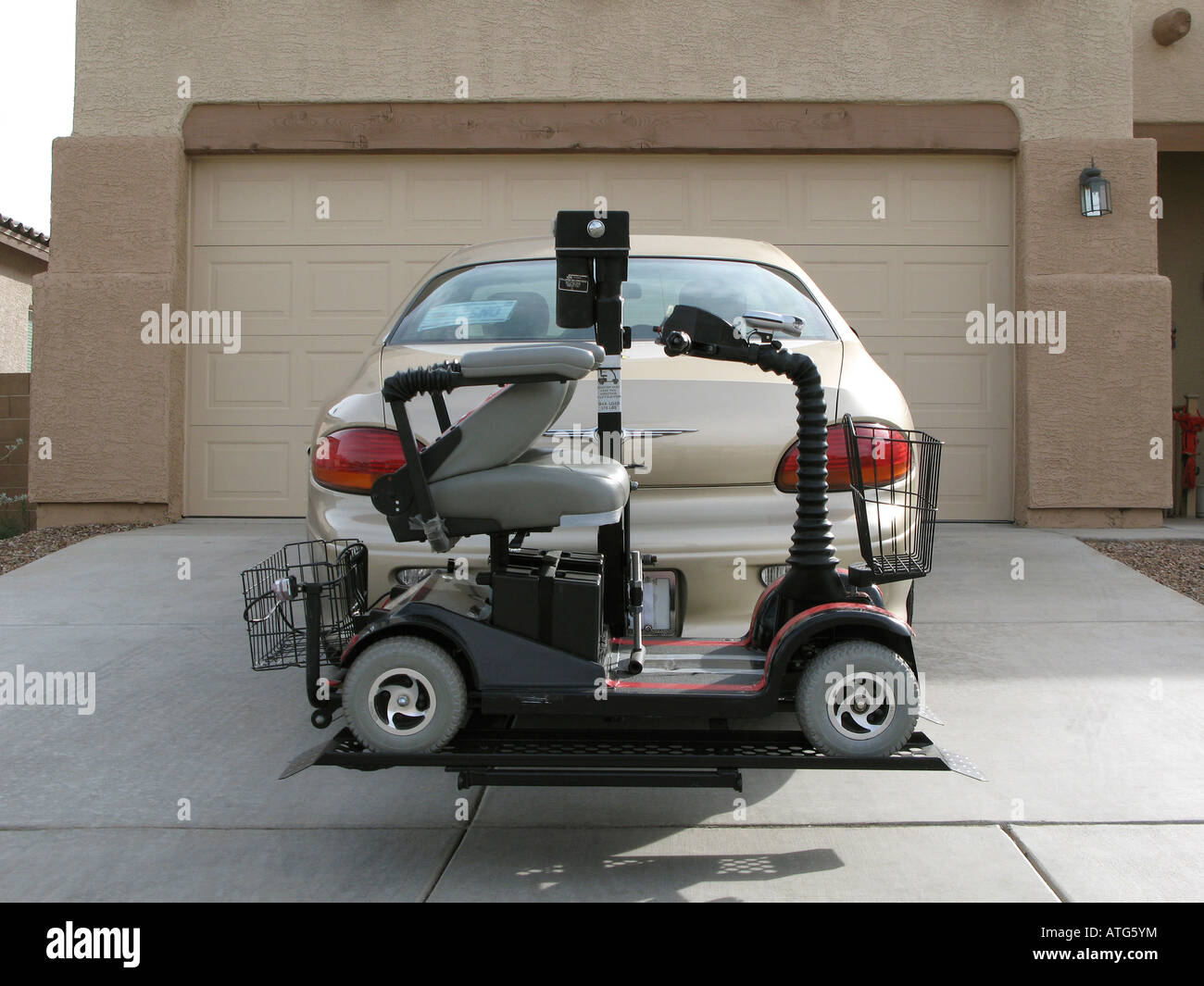 Disability transportation vehicle attached to back of car Stock Photo ...