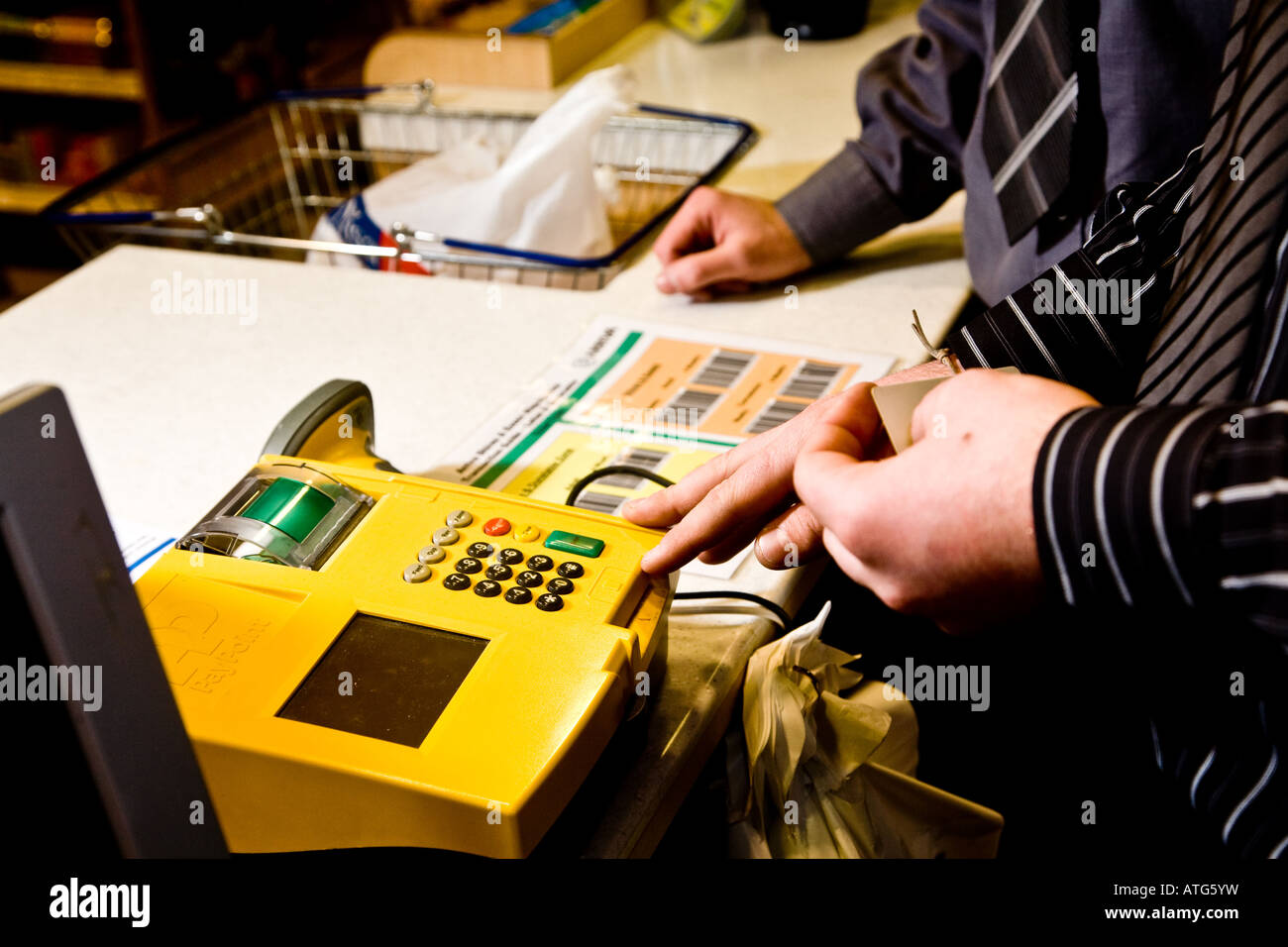 Store staff processing a Paypoint payment at a Convienence store Stock ...