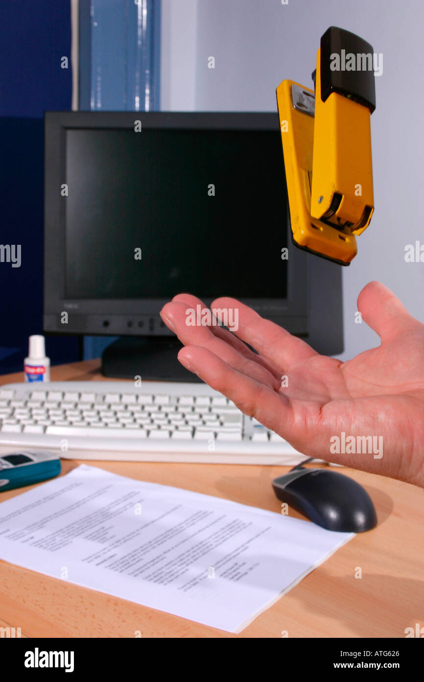 A hand about to grab a flying stapler Stock Photo - Alamy