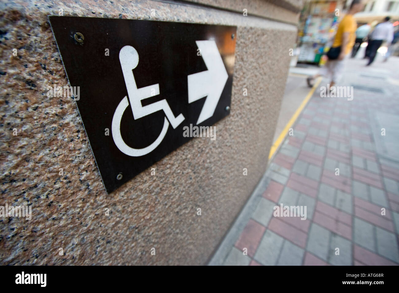 Wheelchair street sign for disabled persons pointing the direction ...