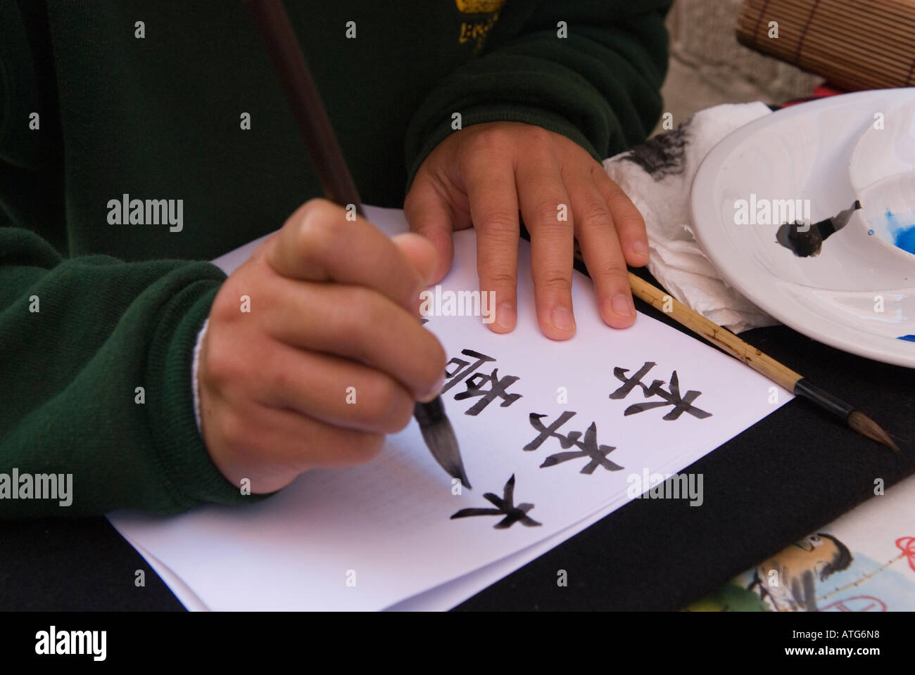 Stock image of a young Chinese Woman Writing Caligraphy in Fredericton ...