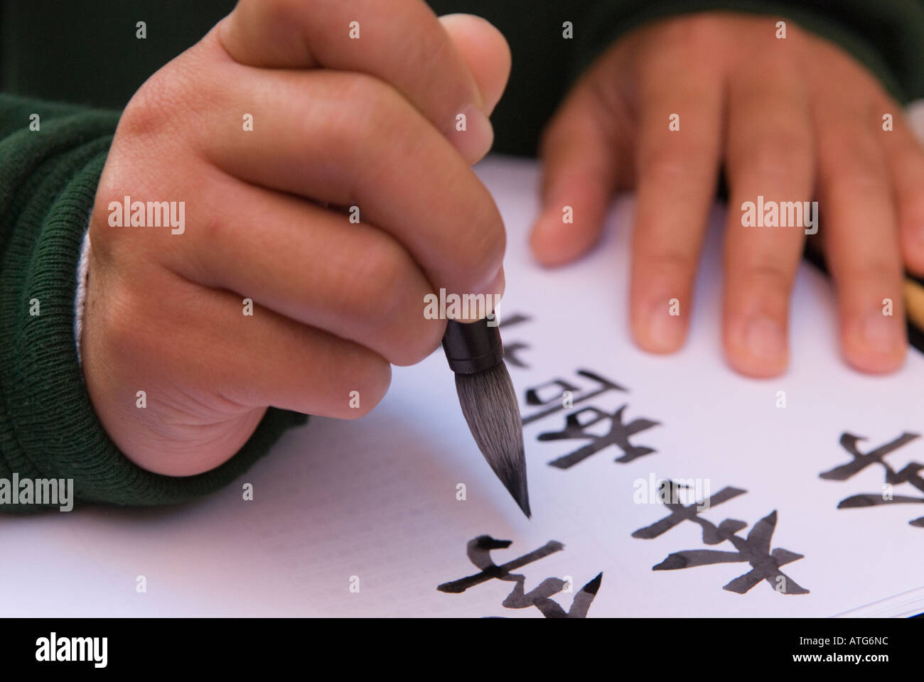 Stock image of a young Chinese Woman Writing Caligraphy in Fredericton ...