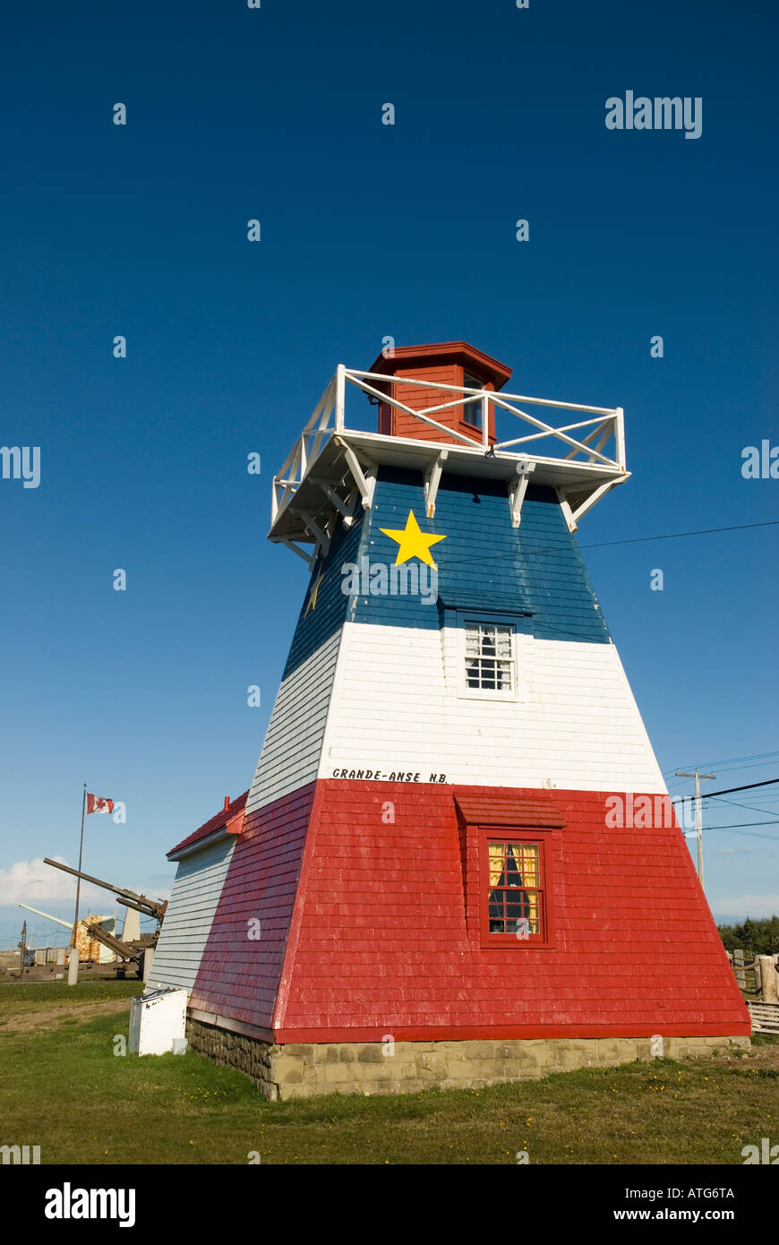 Stock image of a lighthouse in Acadian Colors at sunset with blue sky ...