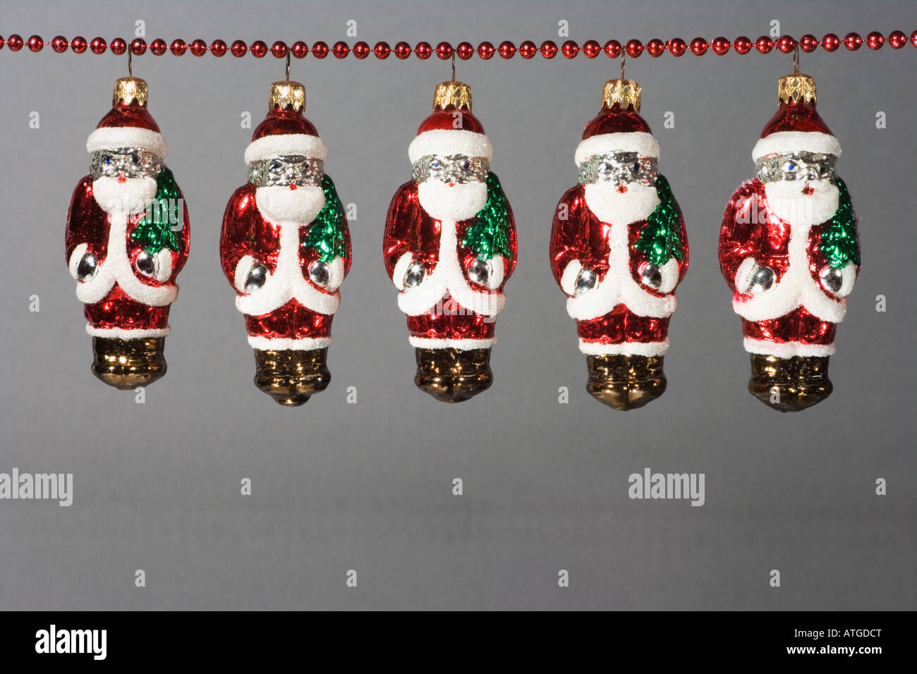 Santa claus decorations hanging in a row Stock Photo - Alamy