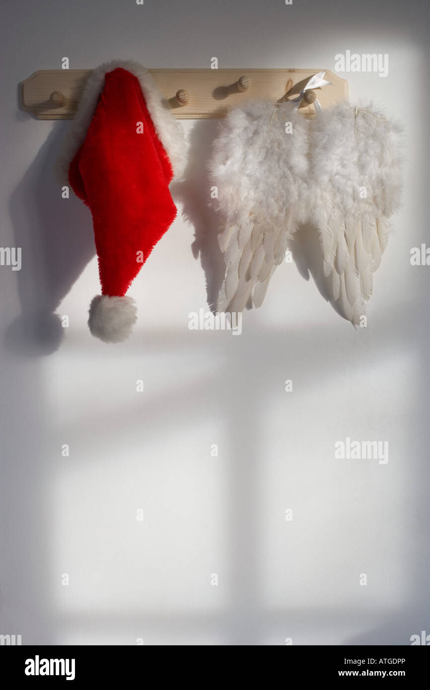 Wings and santas hat hanging on a hook Stock Photo - Alamy