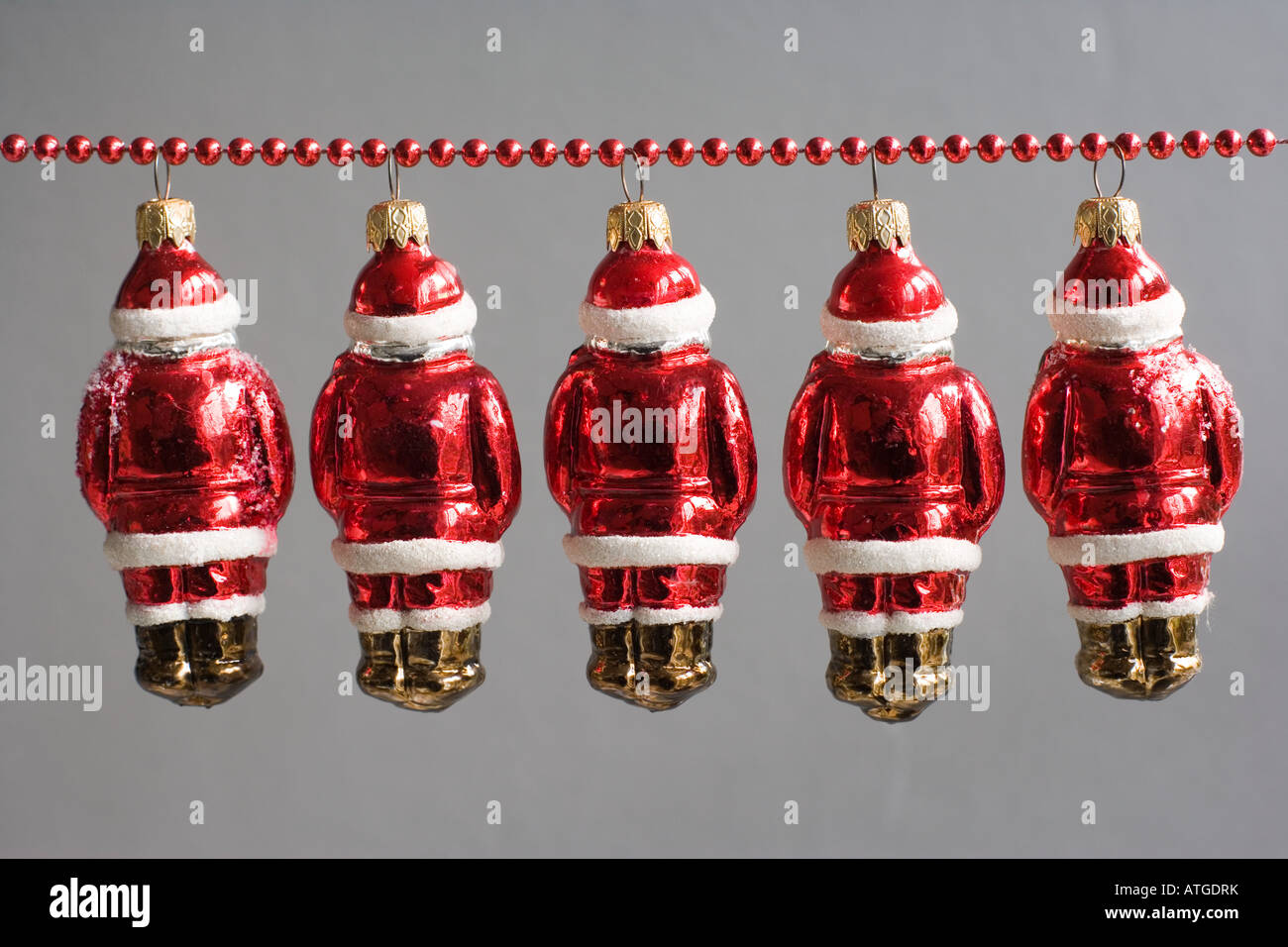 Santa claus decorations hanging in a row Stock Photo - Alamy