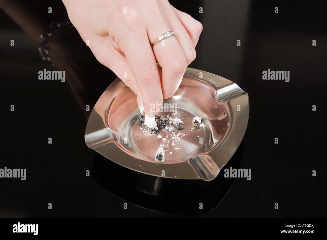Woman stubbing out a cigarette Stock Photo - Alamy