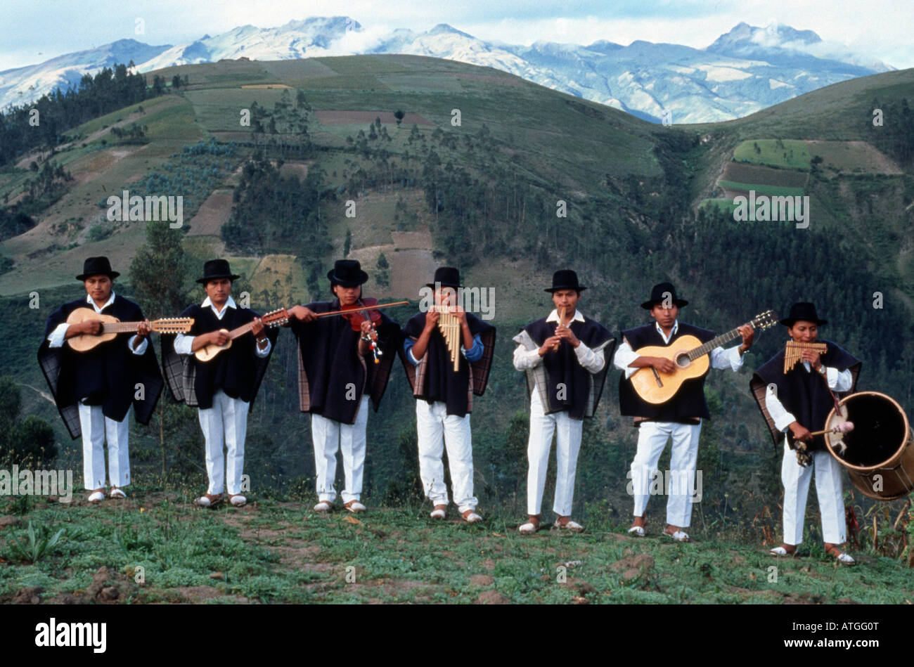 Andean musicians playing their instruments against the background of ...