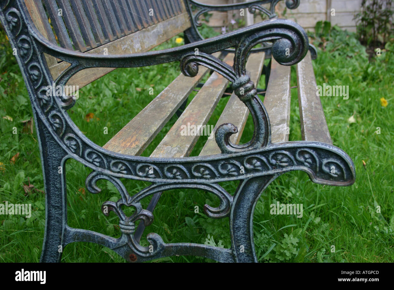 Wooden garden bench on grass in Irish garden Stock Photo - Alamy