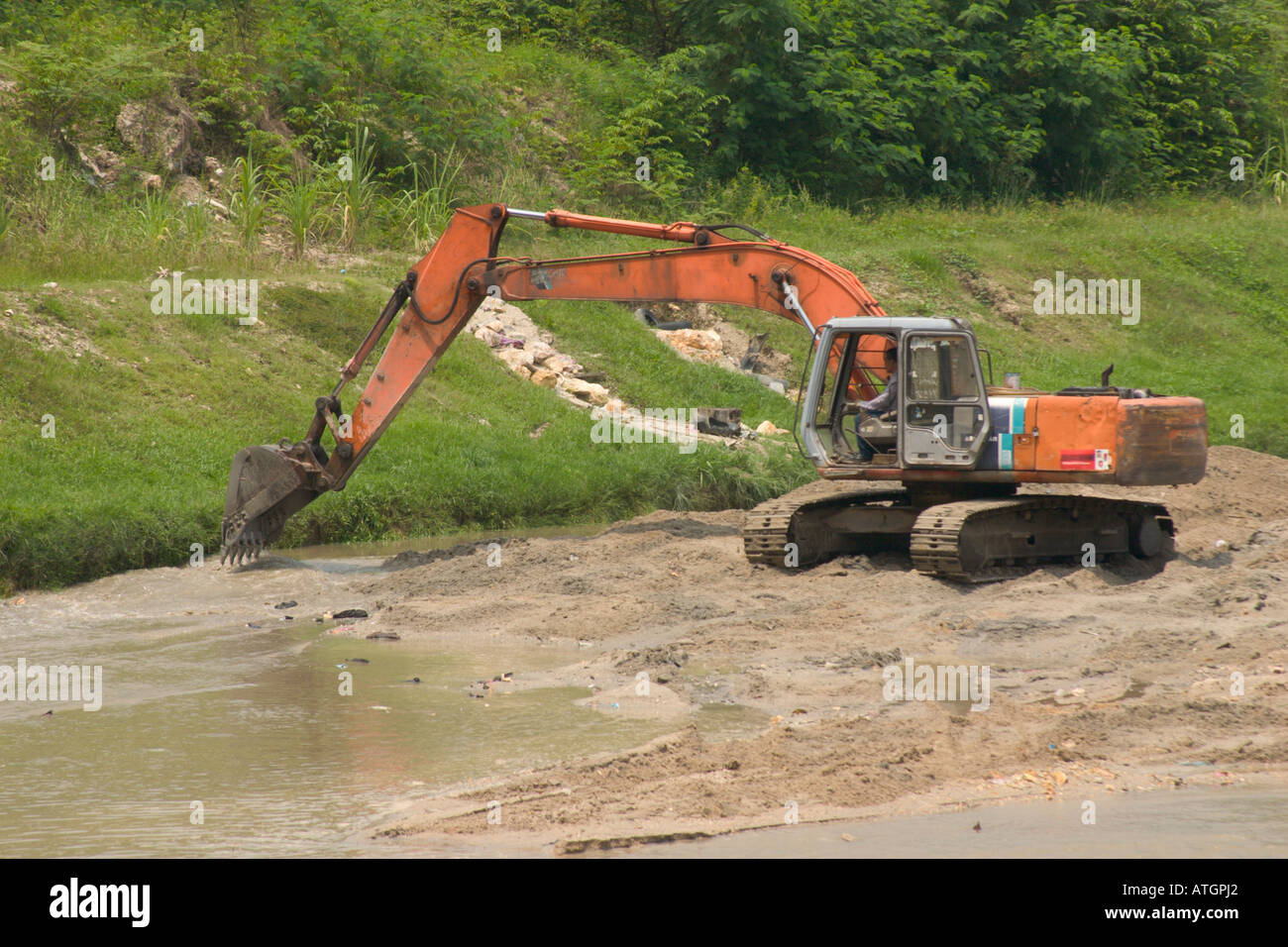 excavator clearing sand from a river Stock Photo - Alamy