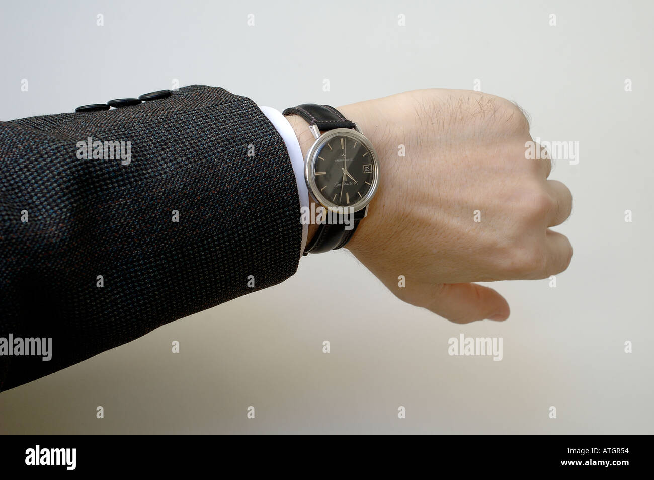Old man checking wrist watch hi-res stock photography and images - Alamy