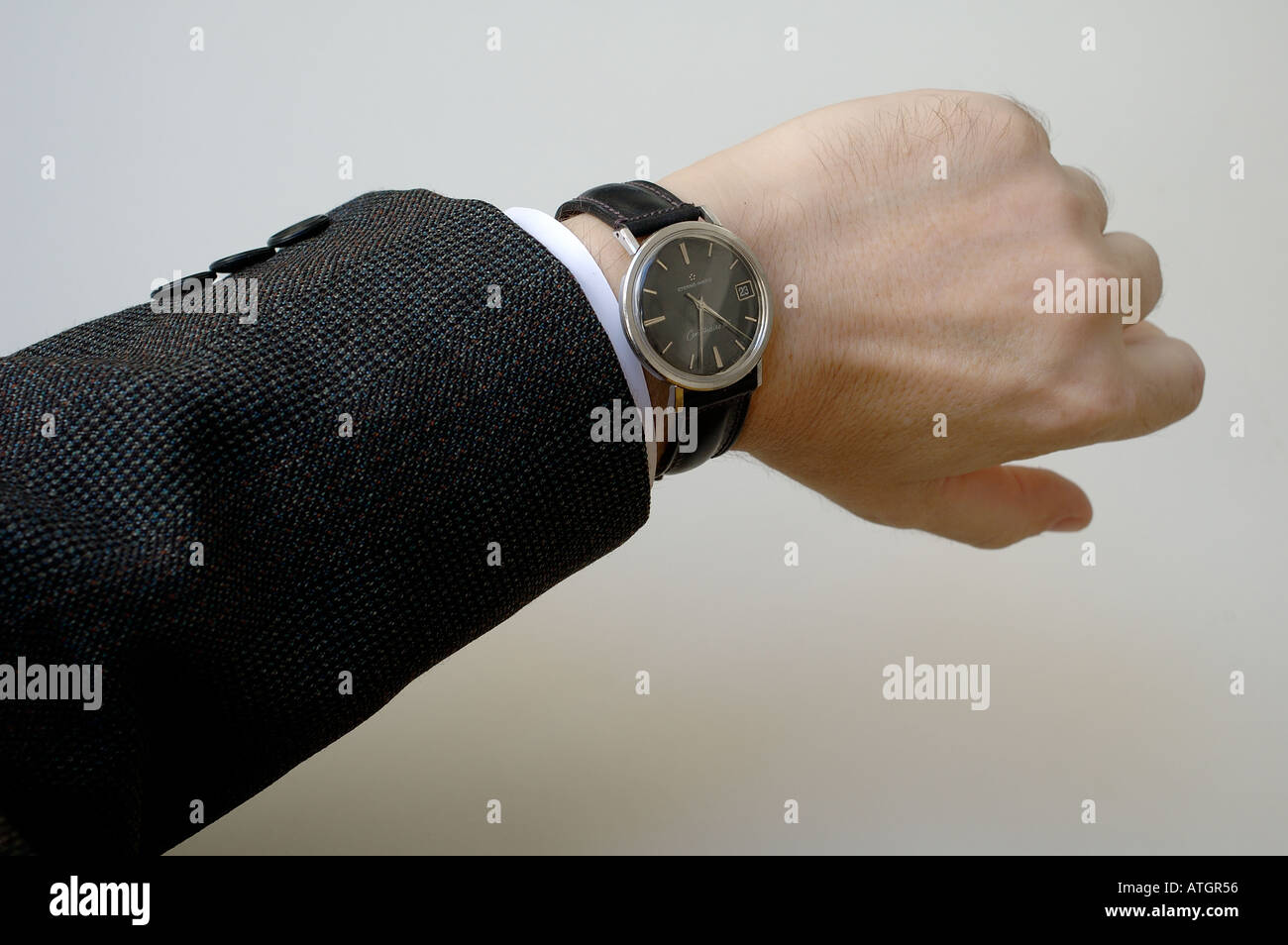 Old man checking wrist watch hi-res stock photography and images - Alamy