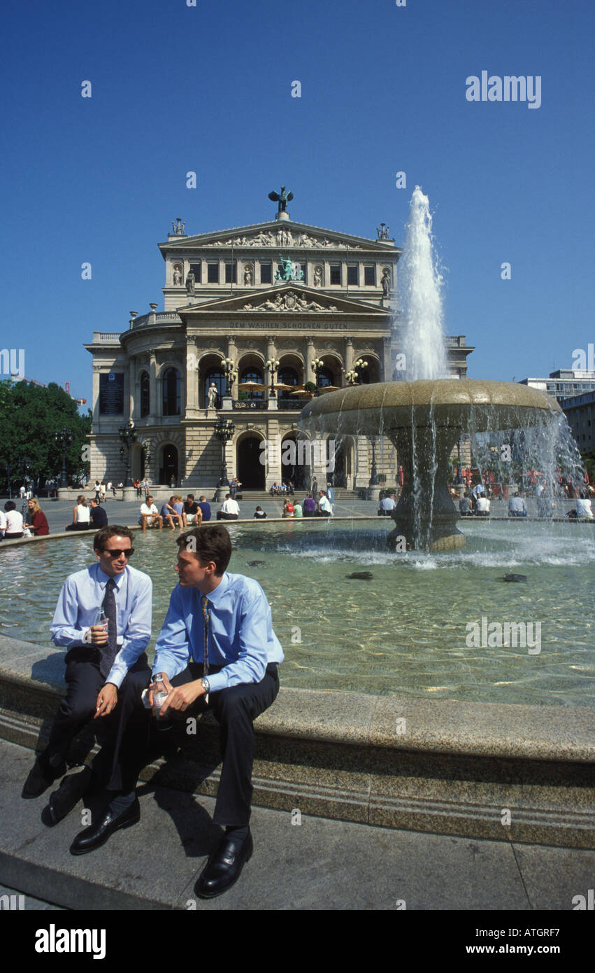 Two men have a break in front of the old opera house at Frankfurt ...