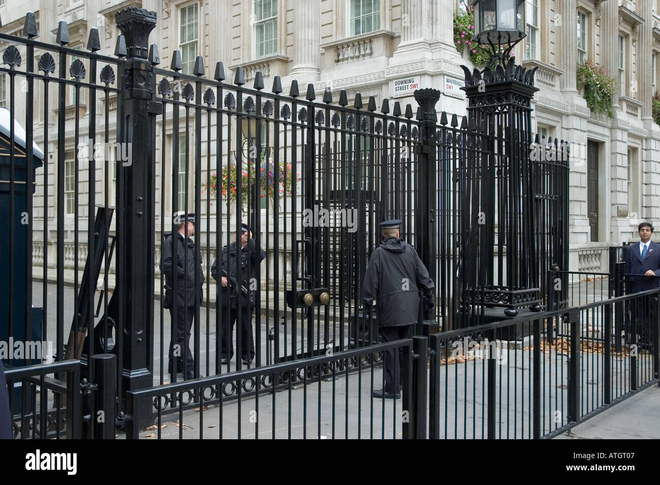 Armed Police at the security gates at the entrance to Downing Street ...