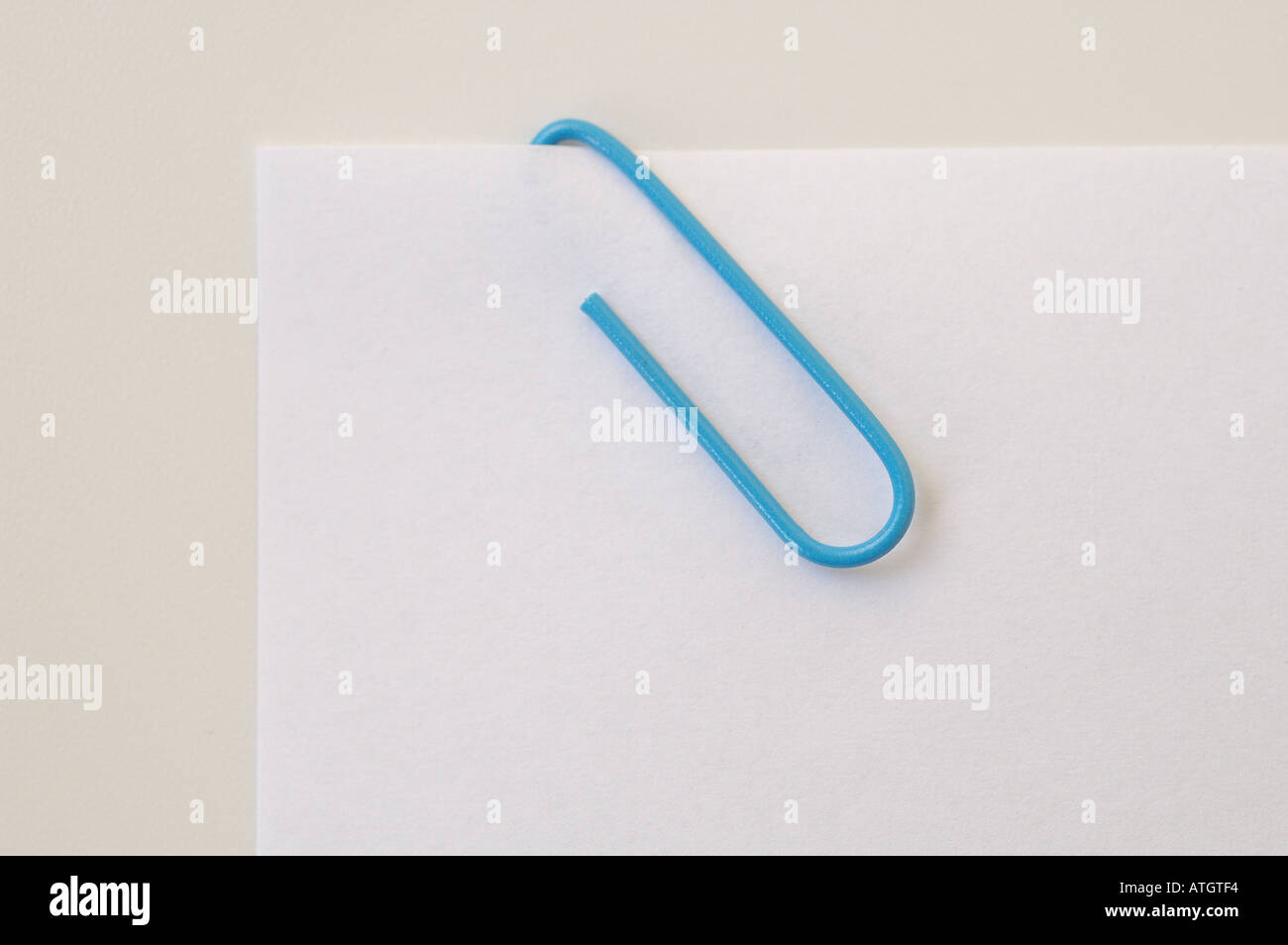 Blue paperclip on white paper Stock Photo - Alamy