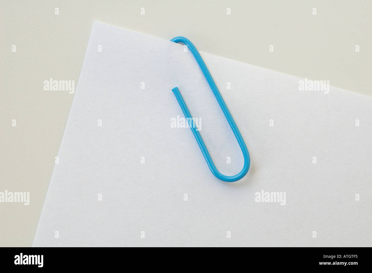Blue paperclip on white paper Stock Photo - Alamy