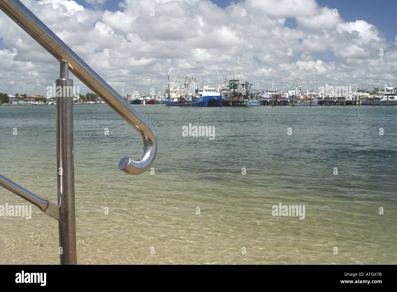 STAINLESS STEEL AND CONCRETE /STEPS STAIRS LEADING TO THE WATER ...