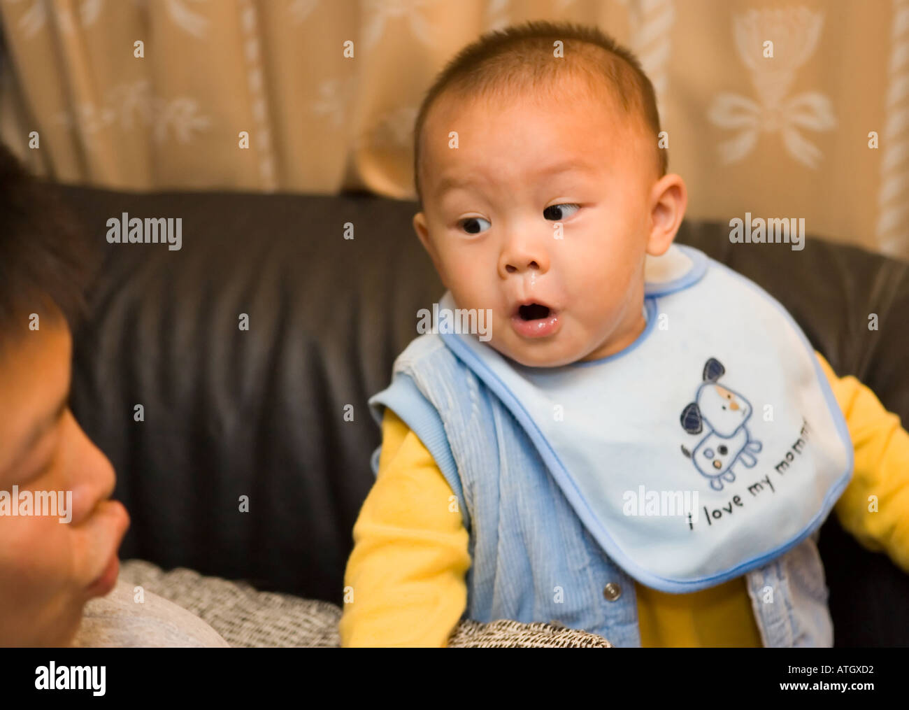 Asian boy making faces to his father Stock Photo - Alamy