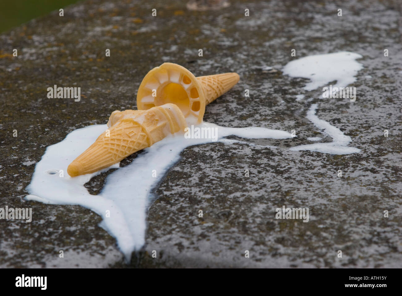 Ice cream cones dropped on the pavement and melted Stock Photo - Alamy