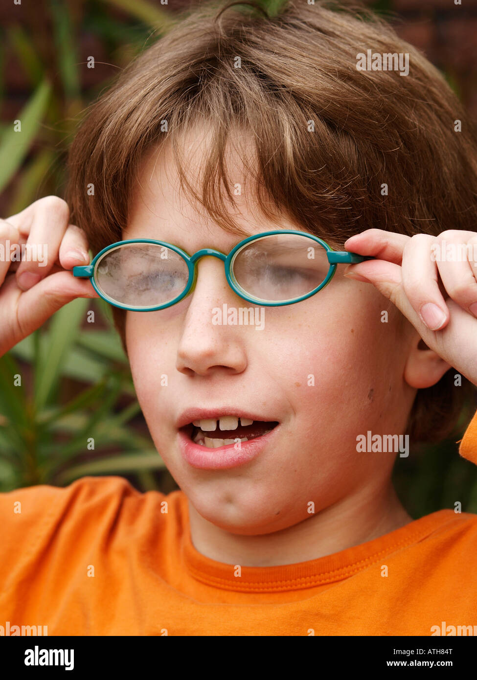Boy with steamed up glasses condensation with tropical plants in the ...