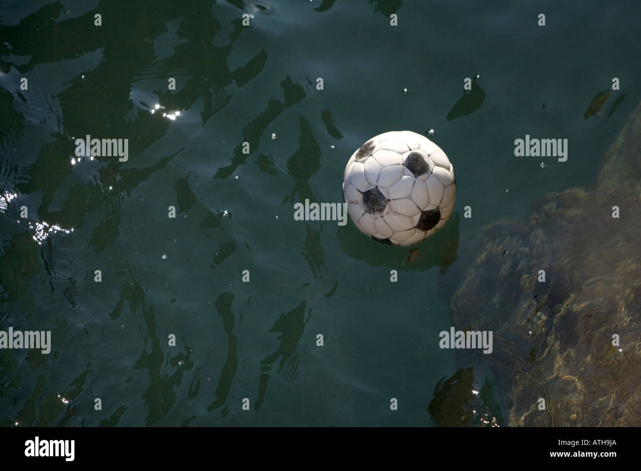 football floating on surface of water Stock Photo - Alamy