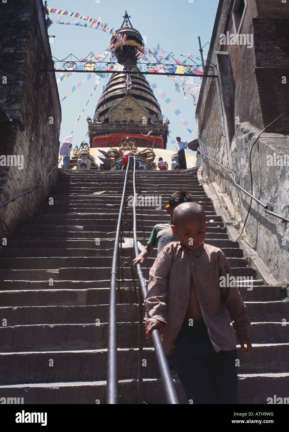 boy walking down temple steps, Swayambhunath Stock Photo - Alamy