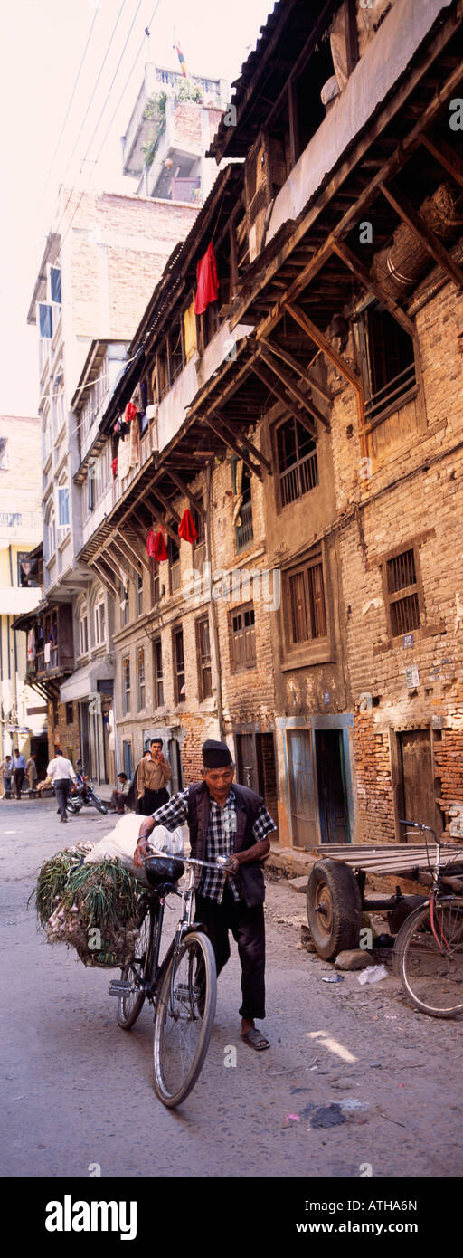 man pushing bike down street, Nepal Stock Photo - Alamy