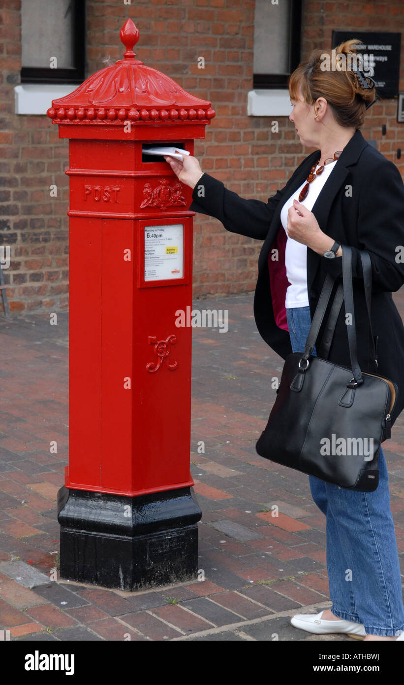 Woman posting letter in post hi-res stock photography and images - Alamy