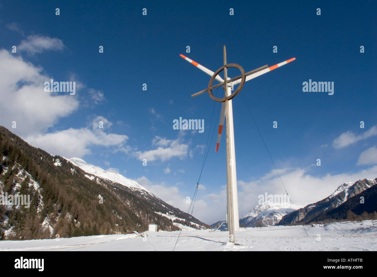 First wind turbine in South Tyrol, Italy, next to religious cross Stock ...