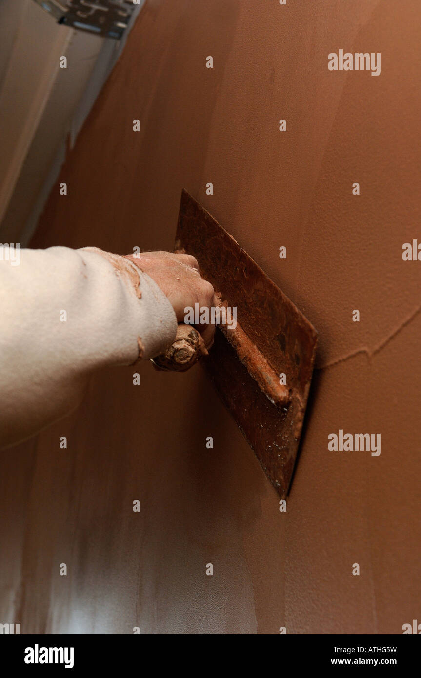 Close up of trowel plastering a wall Stock Photo - Alamy